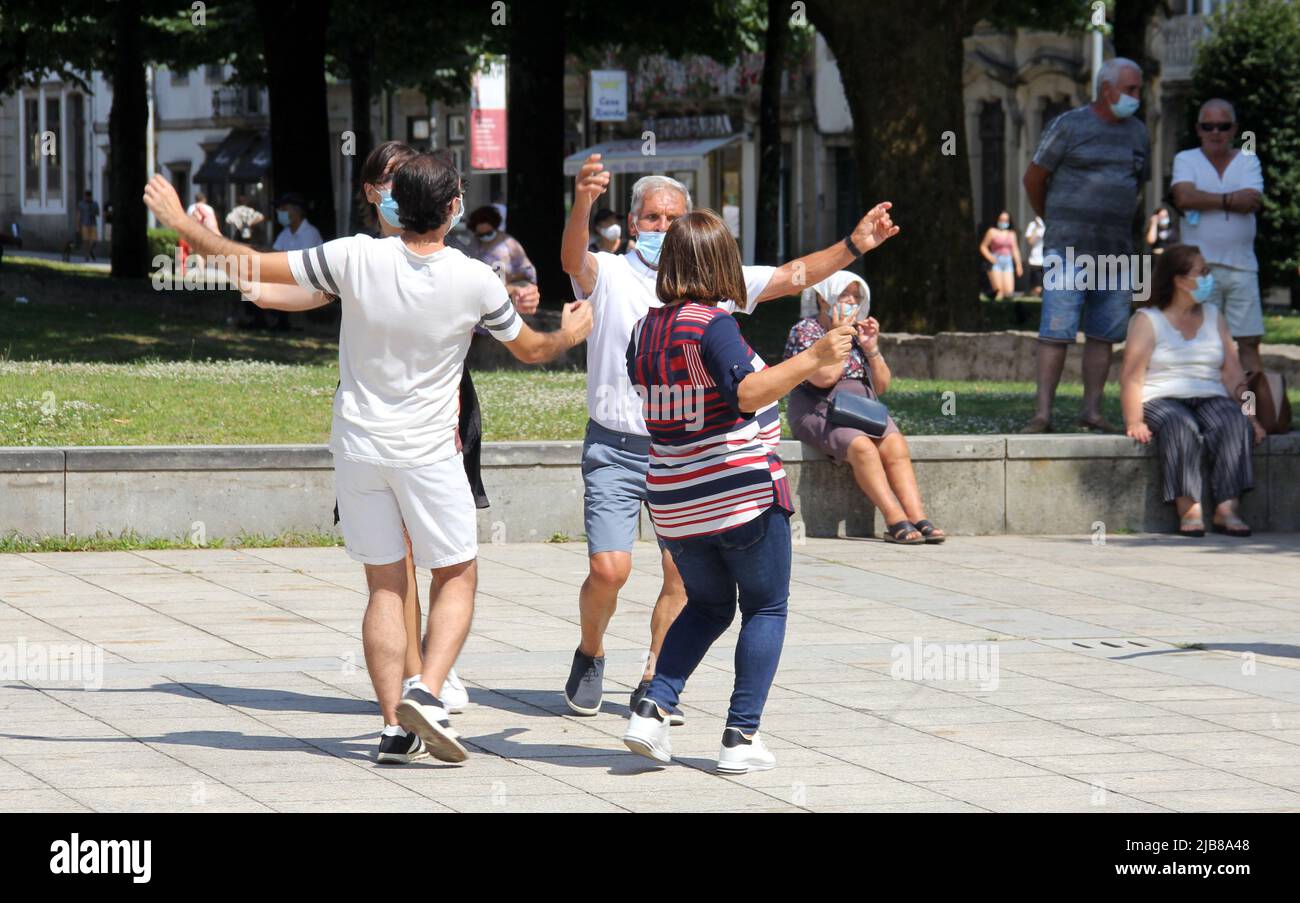 People dancing in the street, traditional folk dance of the region ...