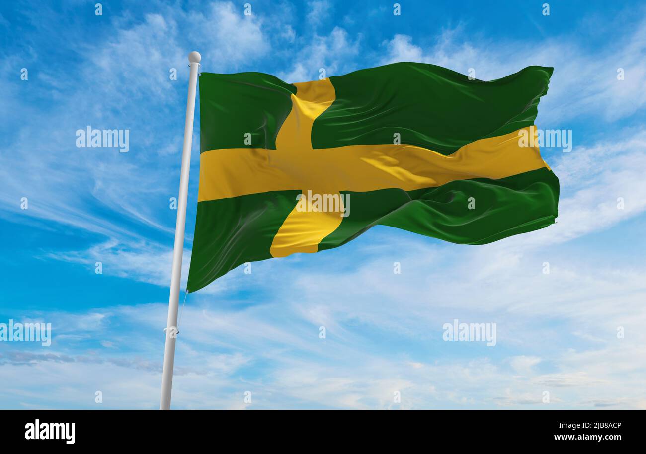 official flag of Oland , Sweden at cloudy sky background on sunset ...