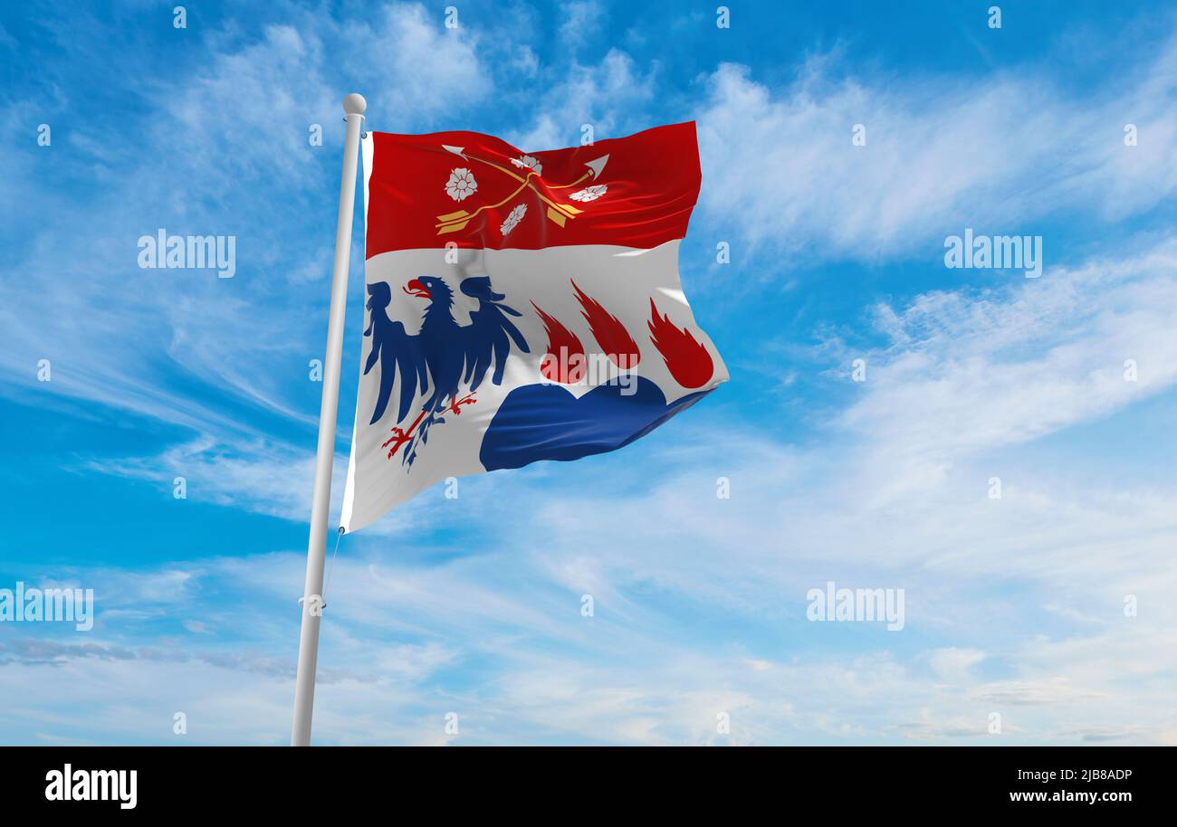 official flag of orebro , Sweden at cloudy sky background on sunset ...