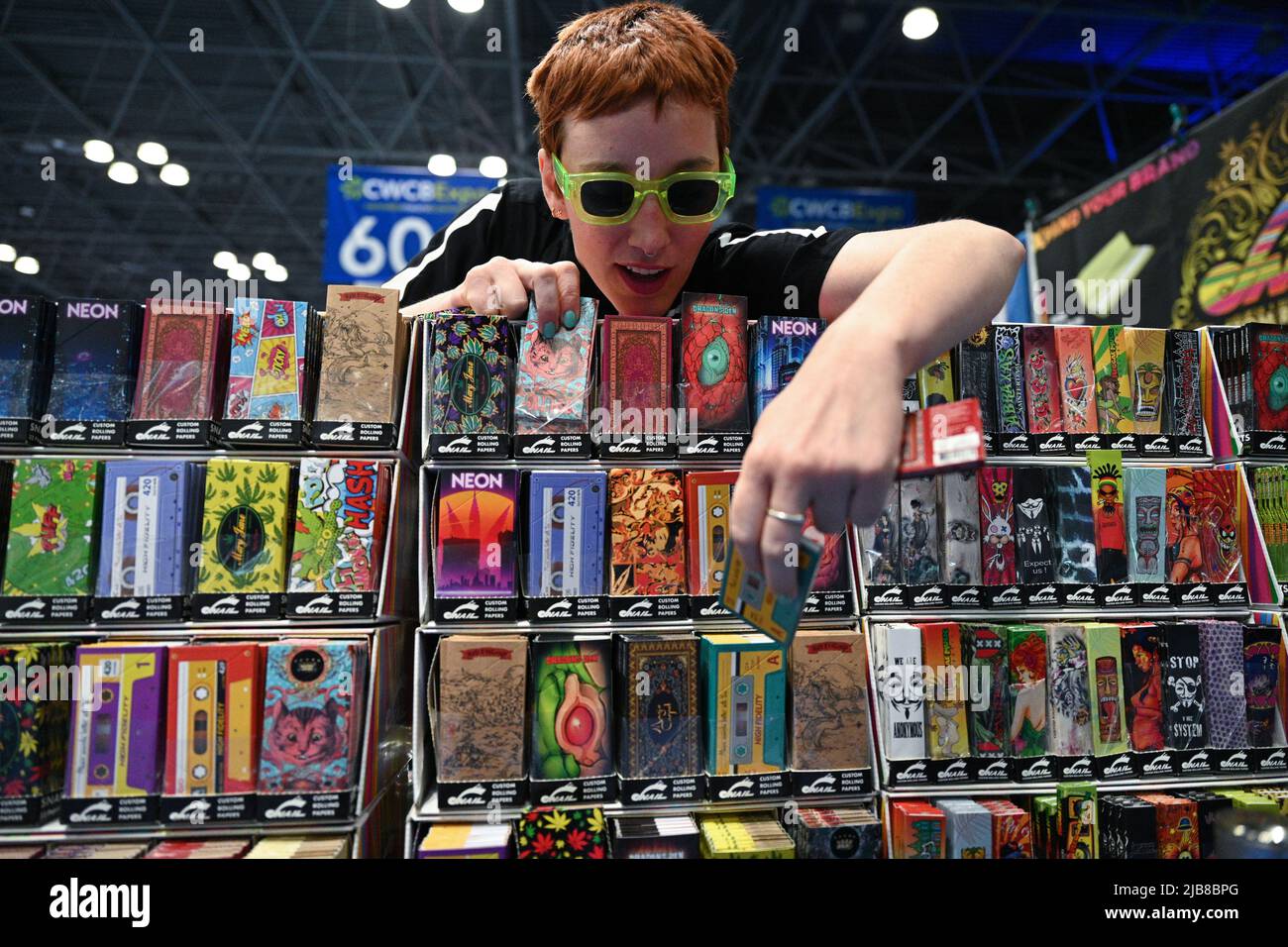 A merchant displays custom rolling papers at the Cannabis World ...