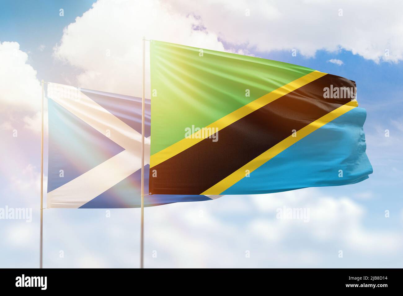 Sunny blue sky and flags of tanzania and scotland Stock Photo - Alamy