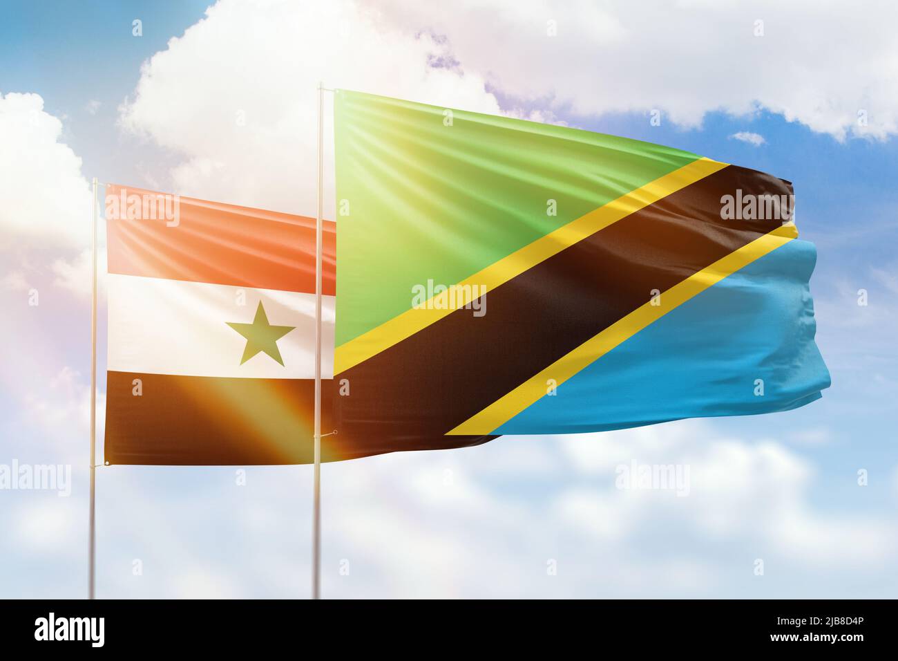 Sunny blue sky and flags of tanzania and syria Stock Photo - Alamy