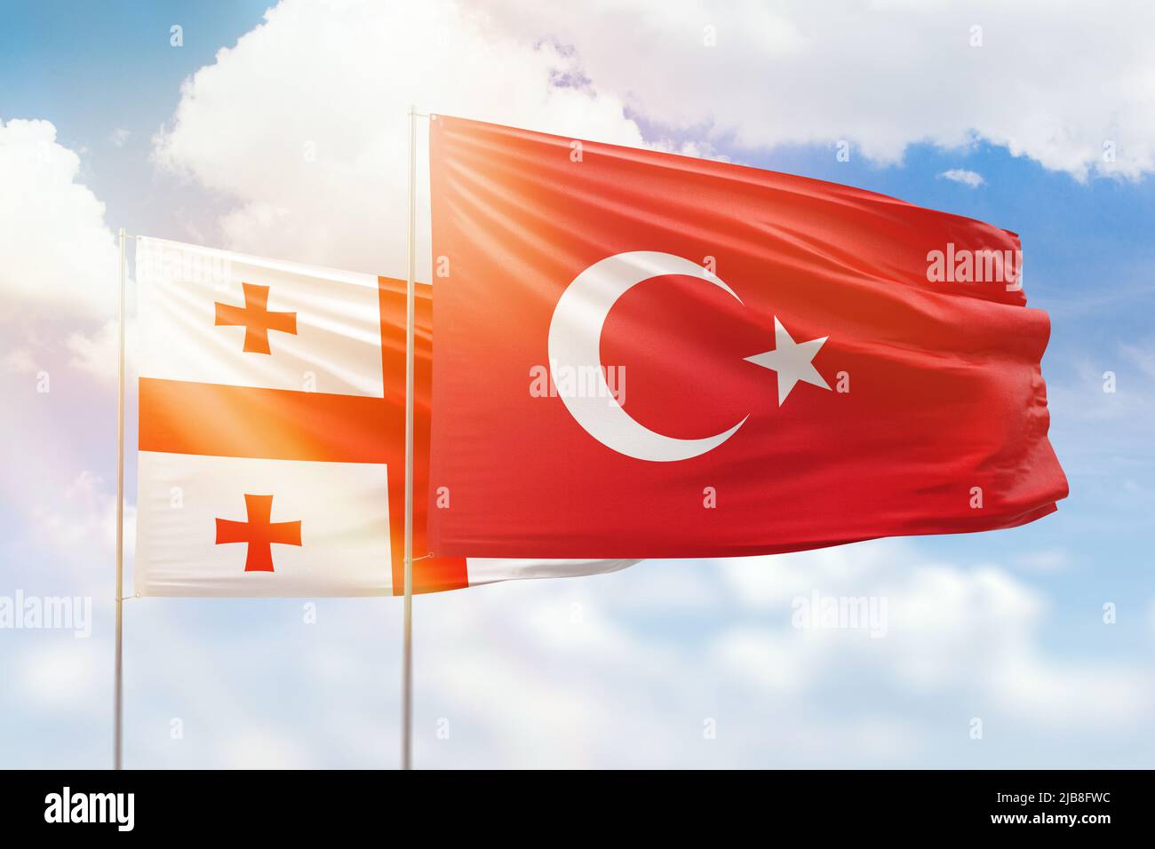 Sunny blue sky and flags of turkey and georgia Stock Photo - Alamy