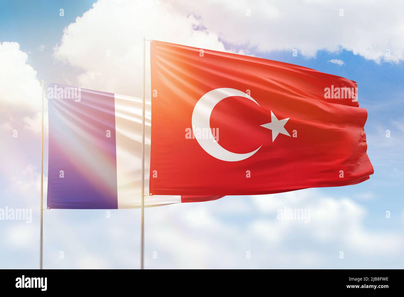 Sunny blue sky and flags of turkey and france Stock Photo - Alamy