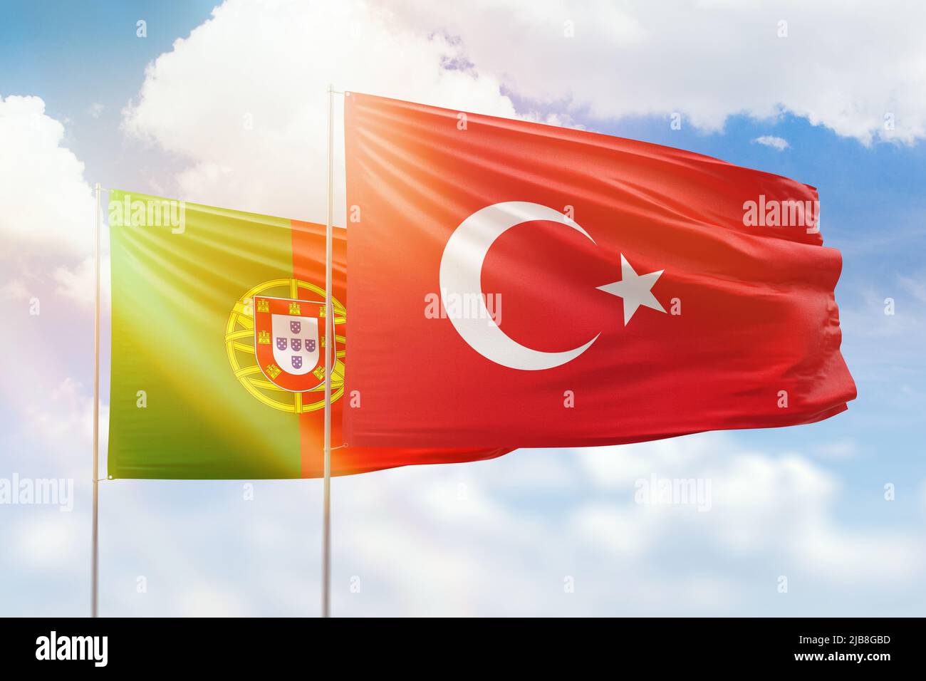 Sunny blue sky and flags of turkey and portugal Stock Photo - Alamy