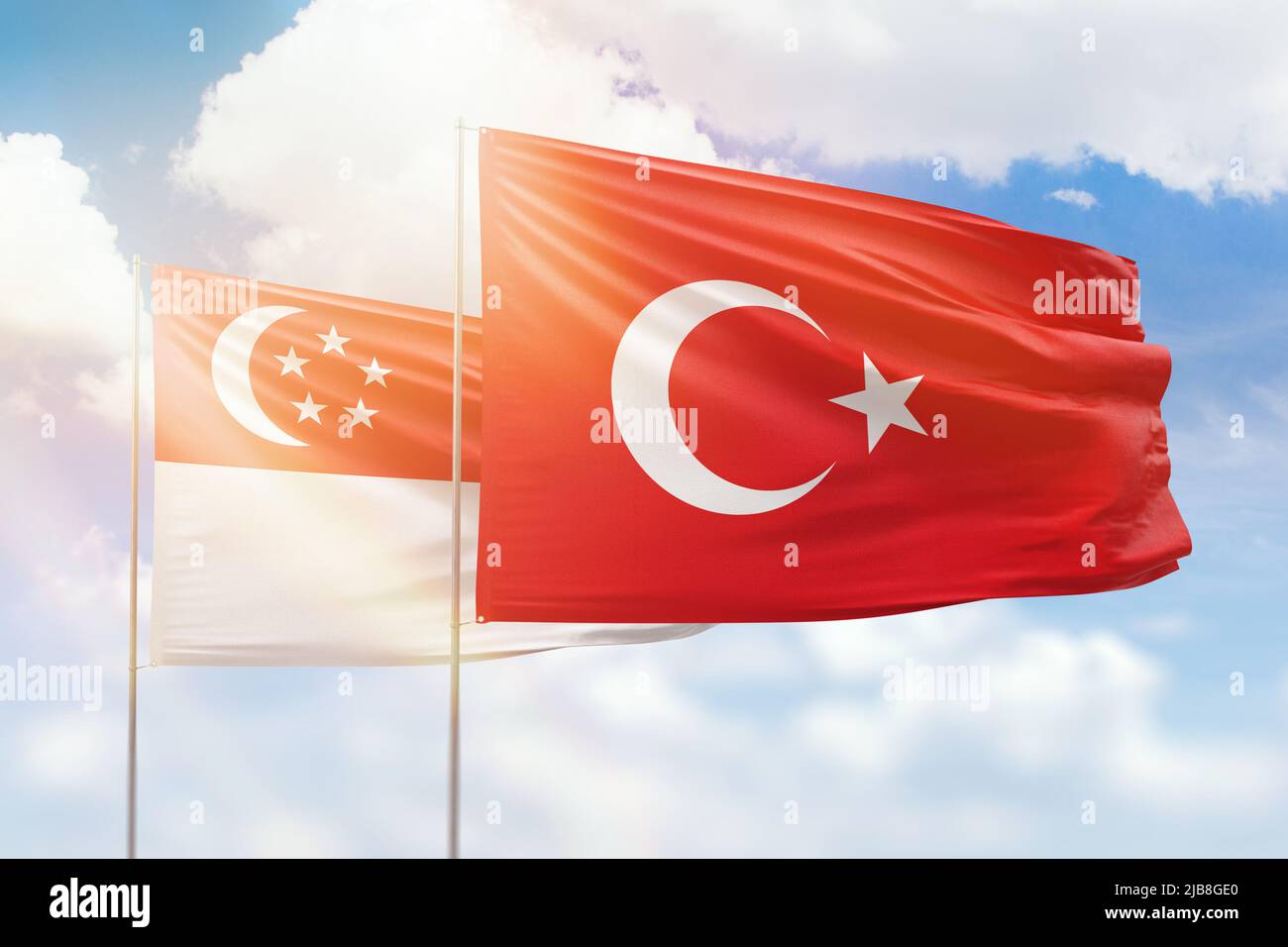 Sunny blue sky and flags of turkey and singapore Stock Photo - Alamy