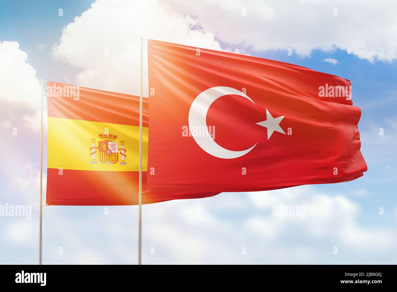 Sunny blue sky and flags of turkey and spain Stock Photo - Alamy