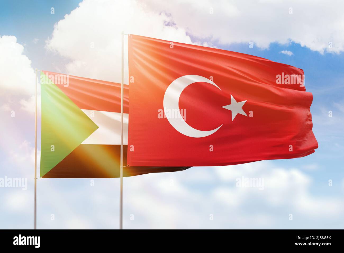 Sunny blue sky and flags of turkey and sudan Stock Photo - Alamy