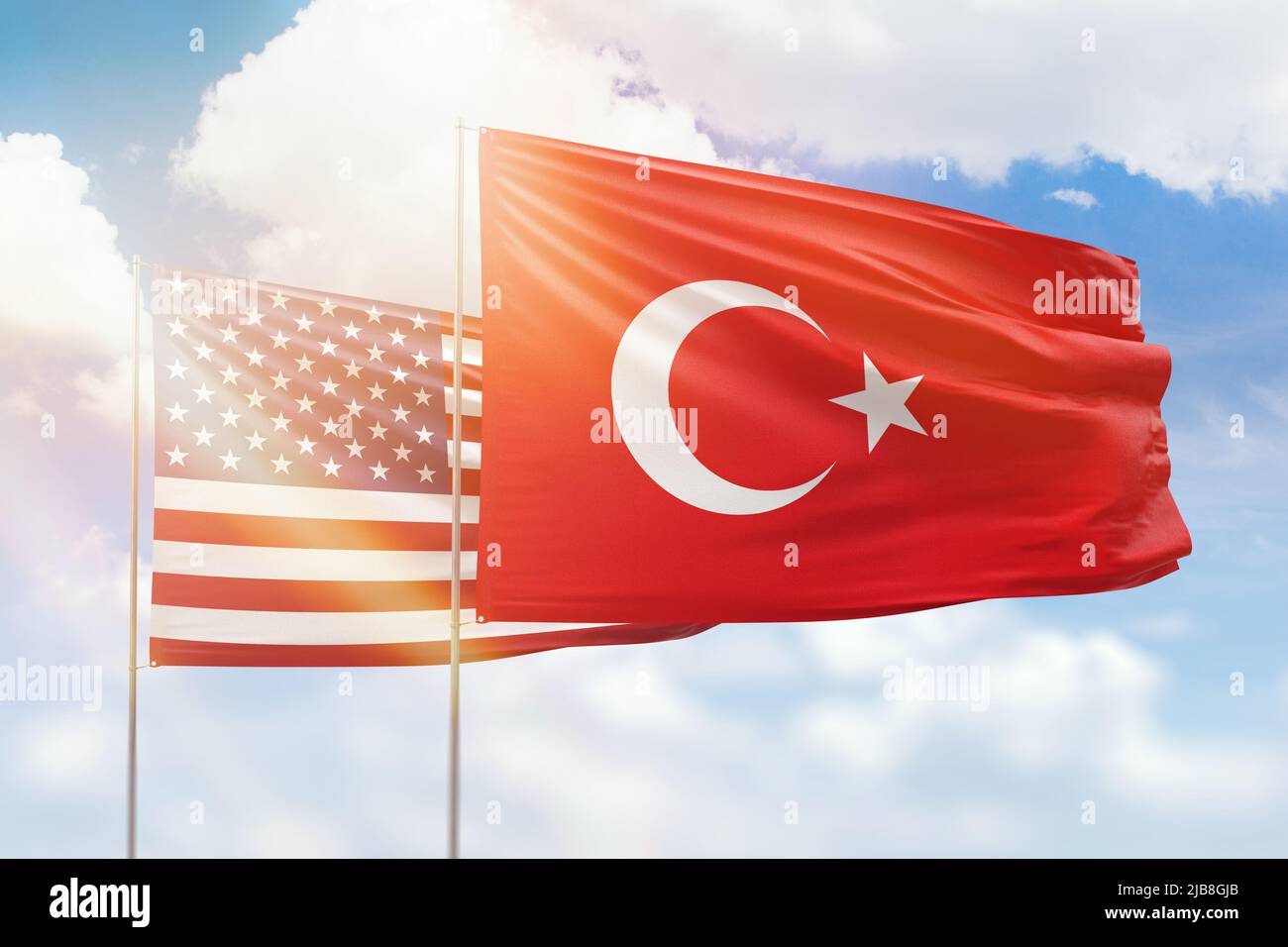 Sunny blue sky and flags of turkey and usa Stock Photo - Alamy