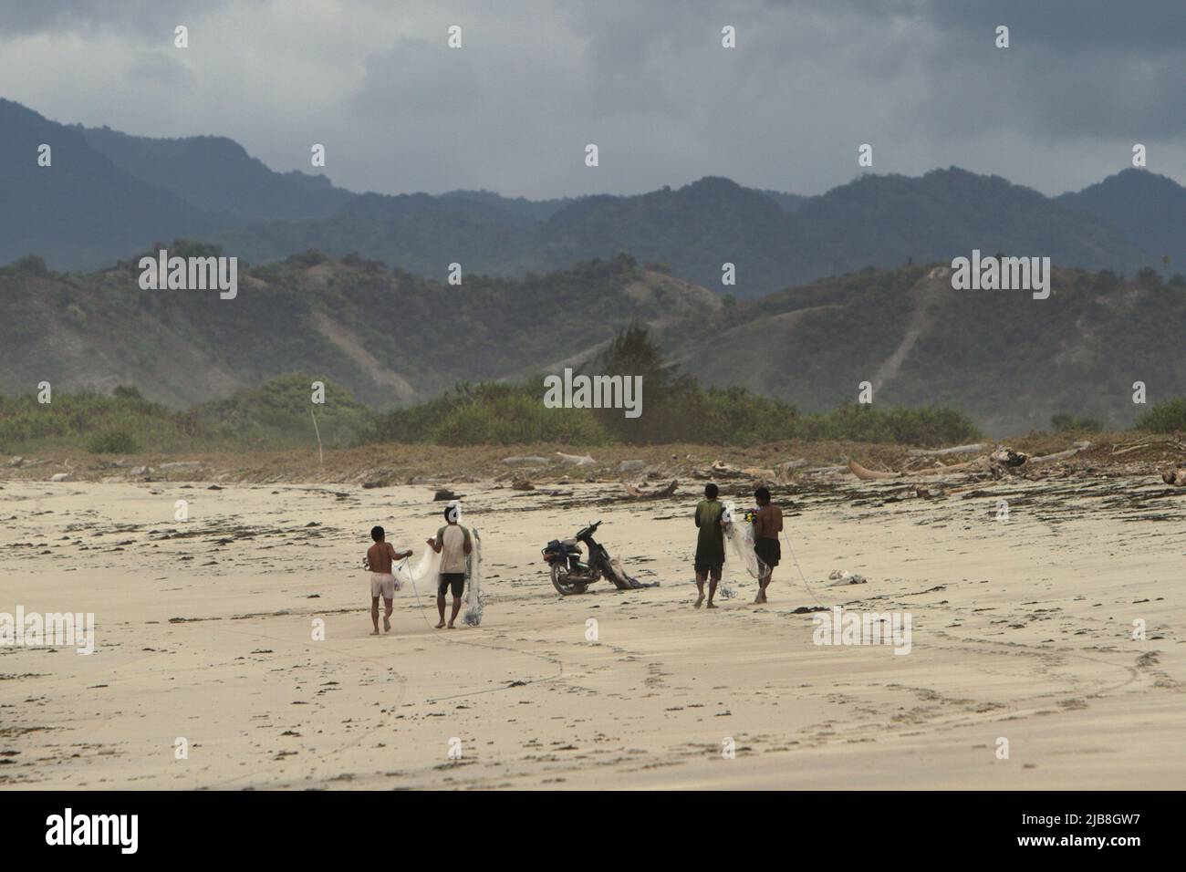 Fishermen carrying fishing nets as they are walking on Kalala beach on ...