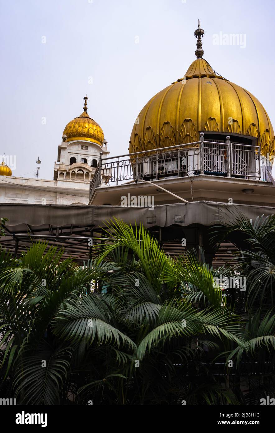 isolated gurudwara building with golden dome and flat sky at morning ...