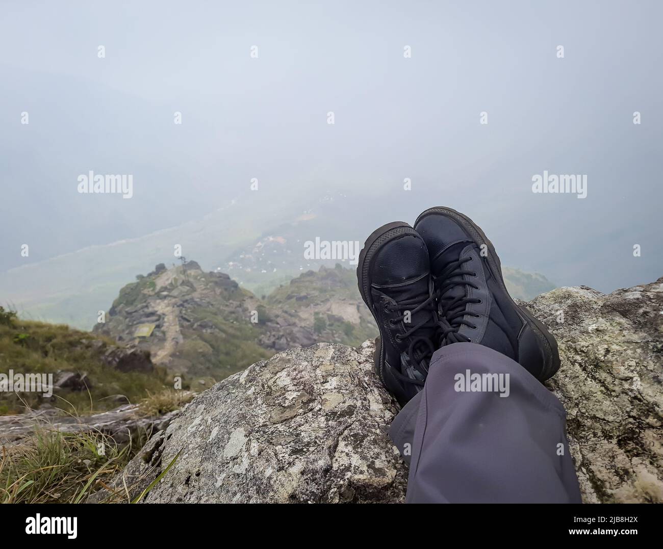 hiker foot resting at mountain top from flat angle at morning Stock ...