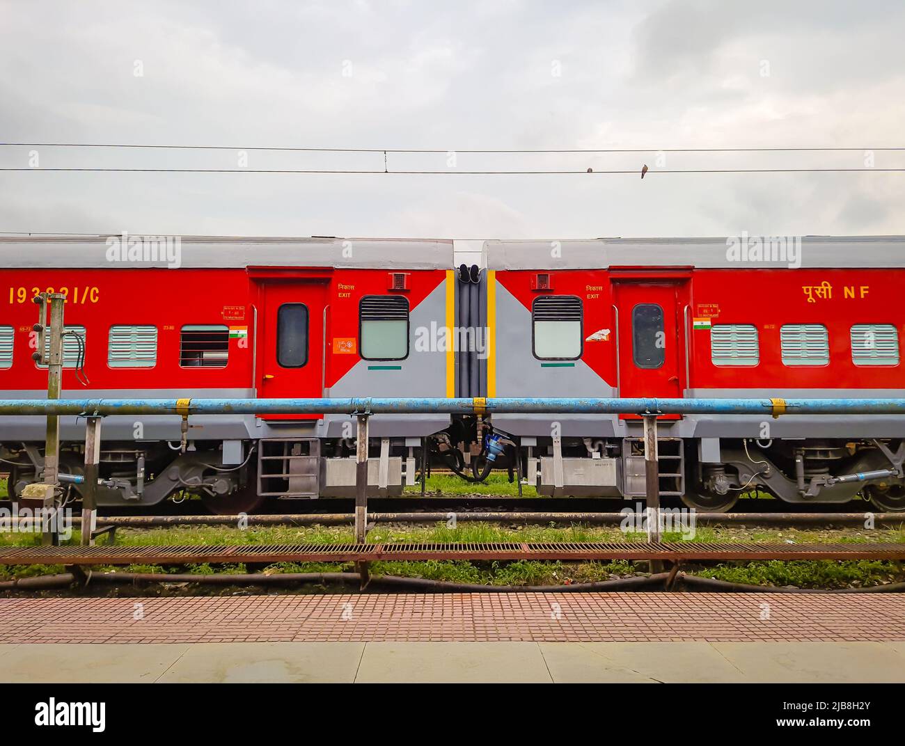 isolated rail passenger coach standing on track at evening from flat ...