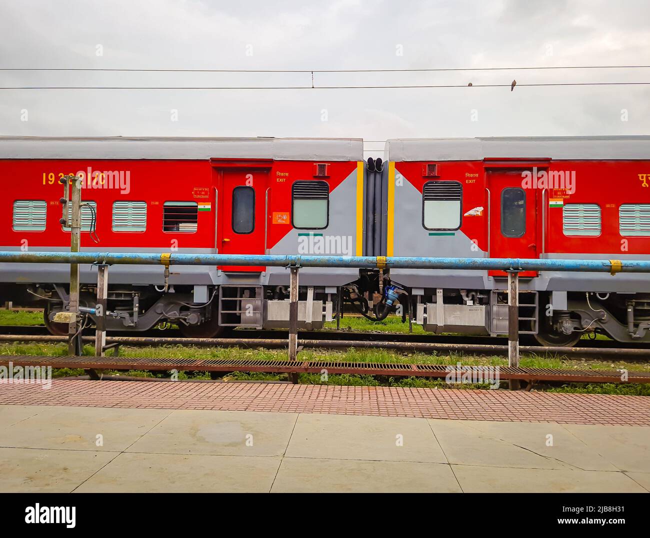isolated rail passenger coach standing on track at evening from flat ...