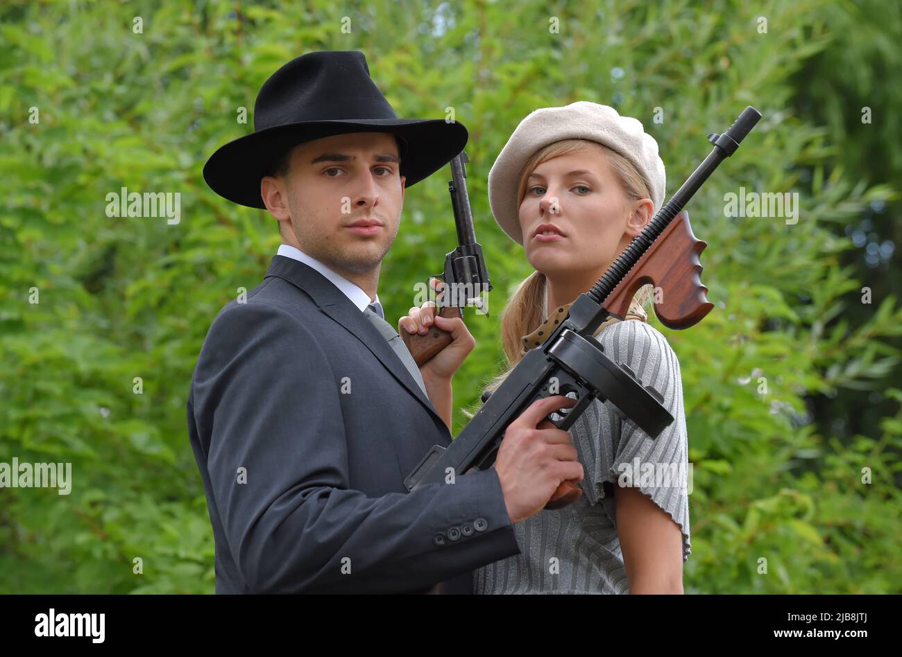 Two people get dressed up in 1930 style vintage fashion clothing. They ...