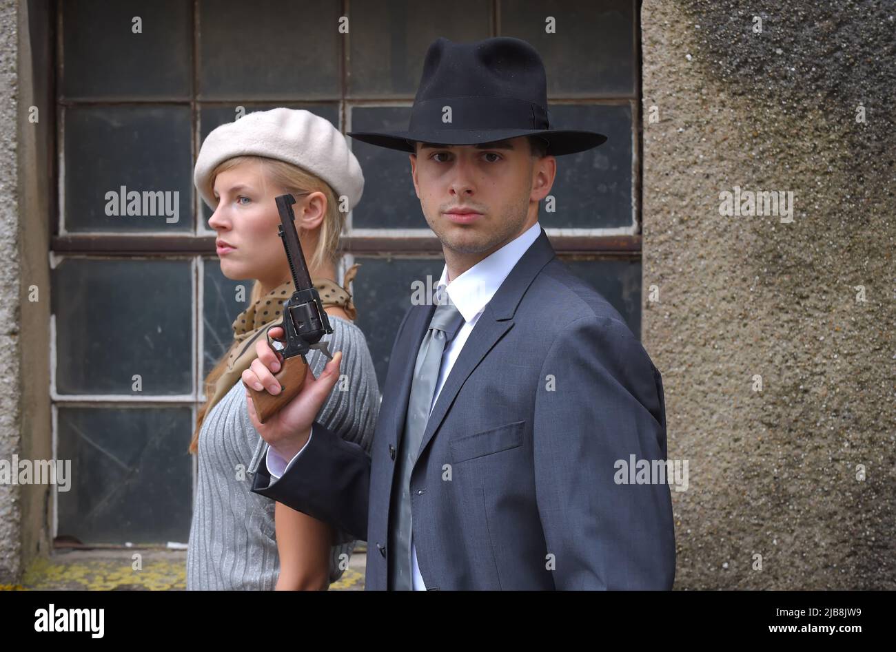 Two people get dressed up in 1930 style vintage fashion clothing. They ...