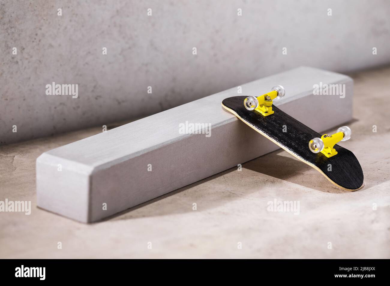 Gray plaster ramp and fingerboard on an abstract background Stock Photo ...