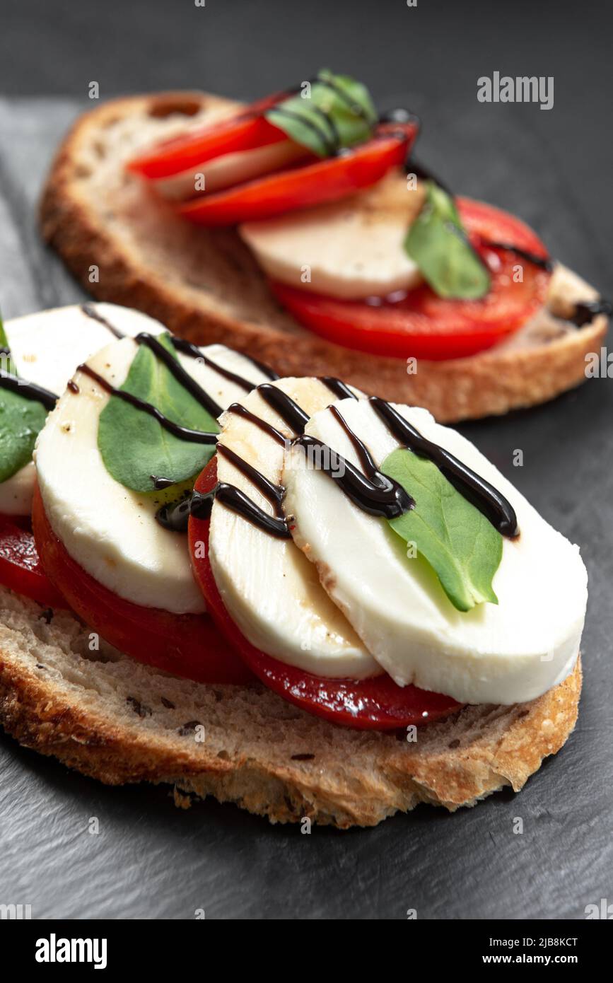 Open sandwiches, in the middle of board an open avocado sandwich made ...