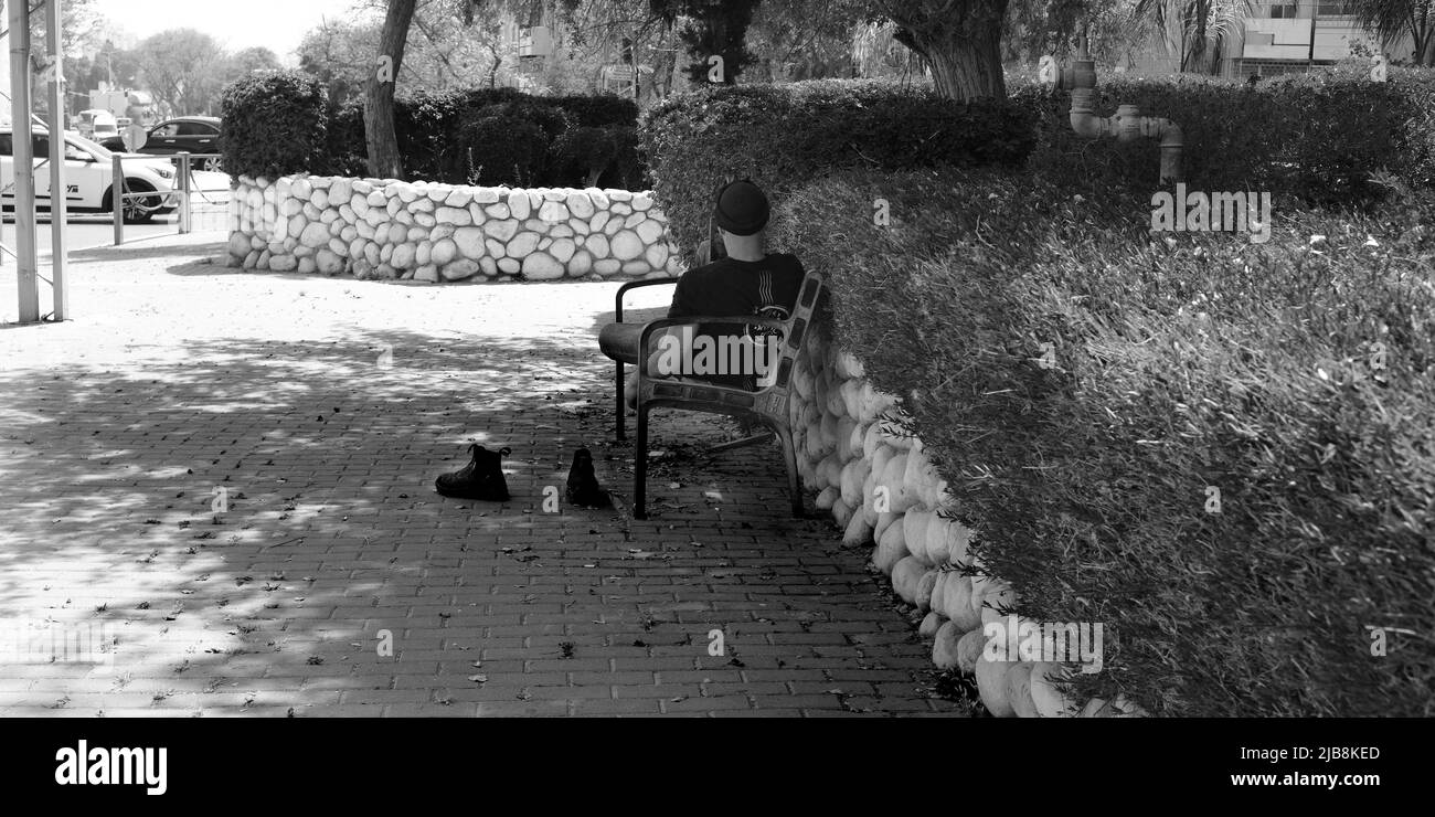 man laying on a bench Stock Photo - Alamy