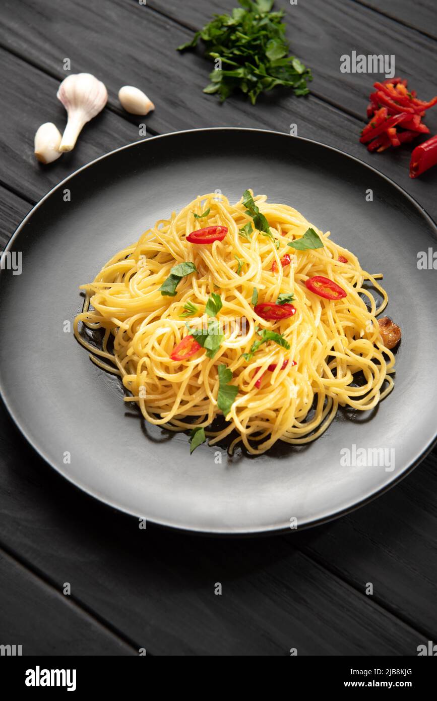 homemade Italian pasta cooked and standing on a black background in a ...