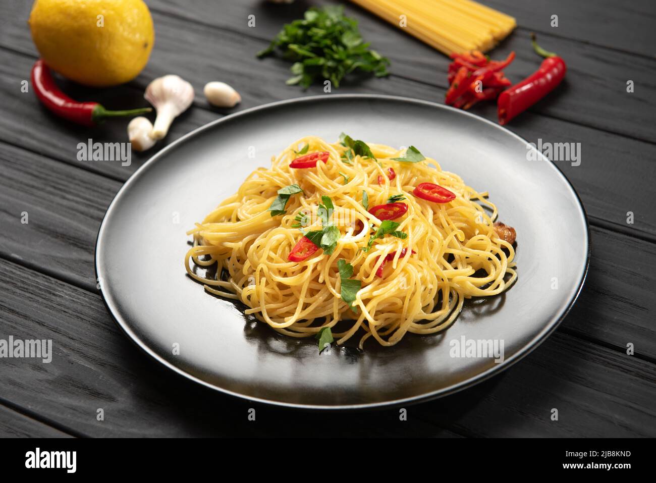 homemade Italian pasta cooked and standing on a black background in a ...