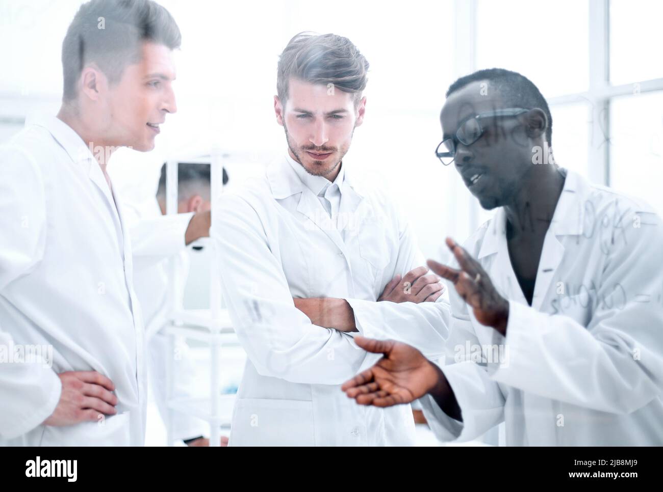 Group of researchers during work on devices in laboratory Stock Photo ...