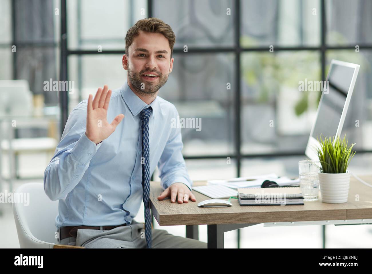 Hello by Man in Office, Indoor Waving Hand Stock Photo - Alamy
