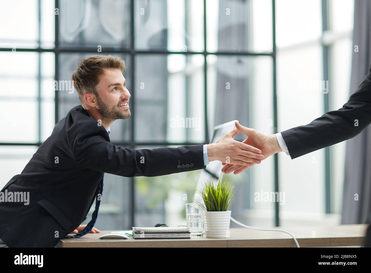 Hello by Man in Office, Indoor Waving Hand Stock Photo - Alamy
