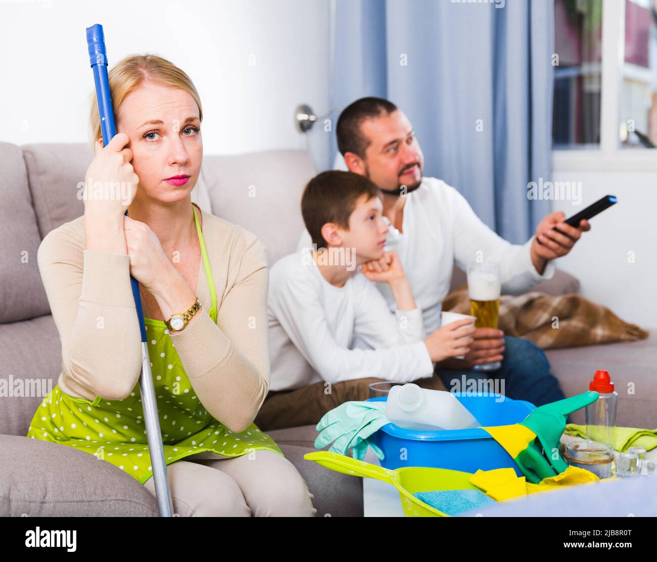 Sad woman tired after cleaning Stock Photo - Alamy