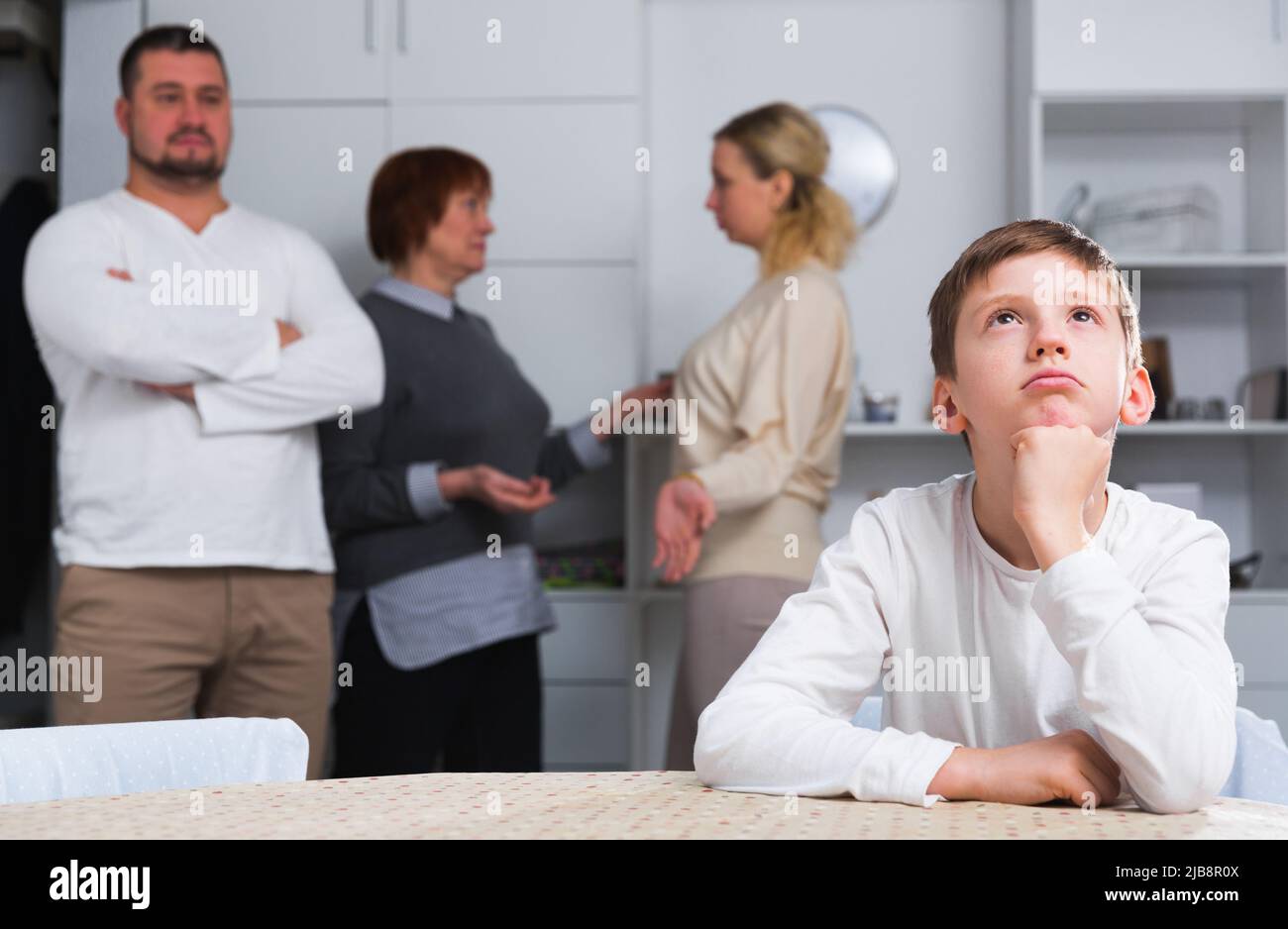 Sad boy during parents quarrel Stock Photo - Alamy