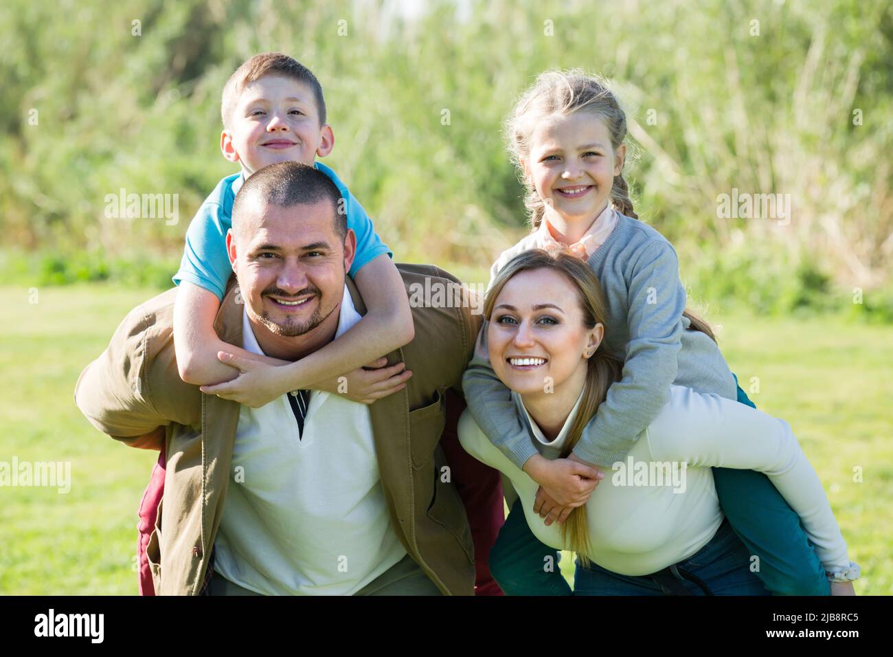 Joyful parents with children outdoor Stock Photo - Alamy