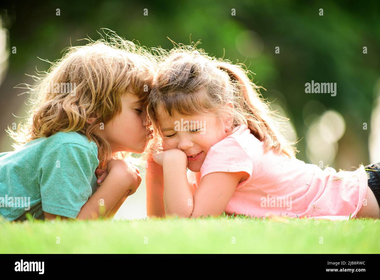 Child boy and girl hugging each other with love in the spring garden ...