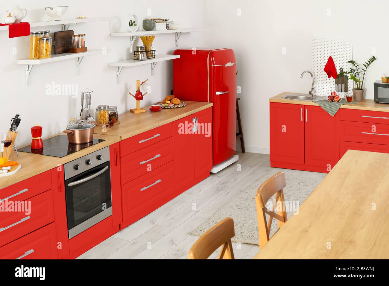 Interior of light kitchen with red fridge and furniture Stock Photo - Alamy