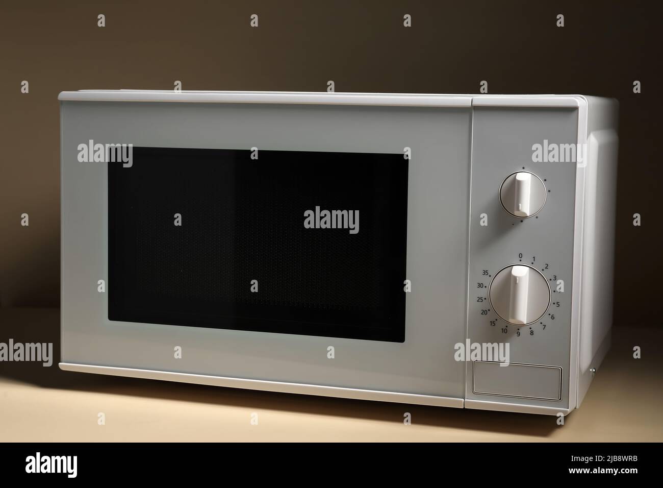 New modern microwave oven on color background Stock Photo - Alamy