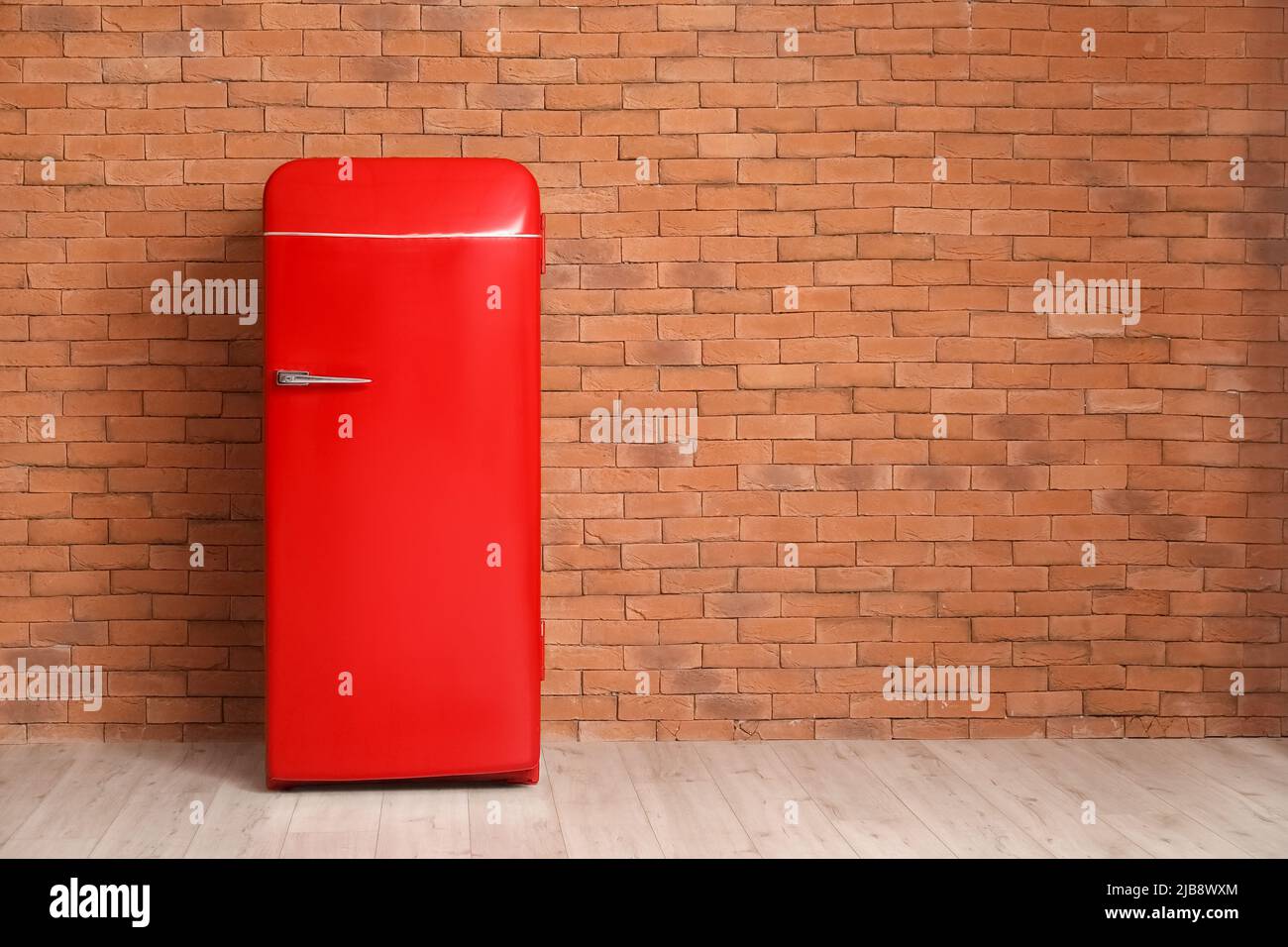 Stylish retro fridge near brick wall in room Stock Photo - Alamy