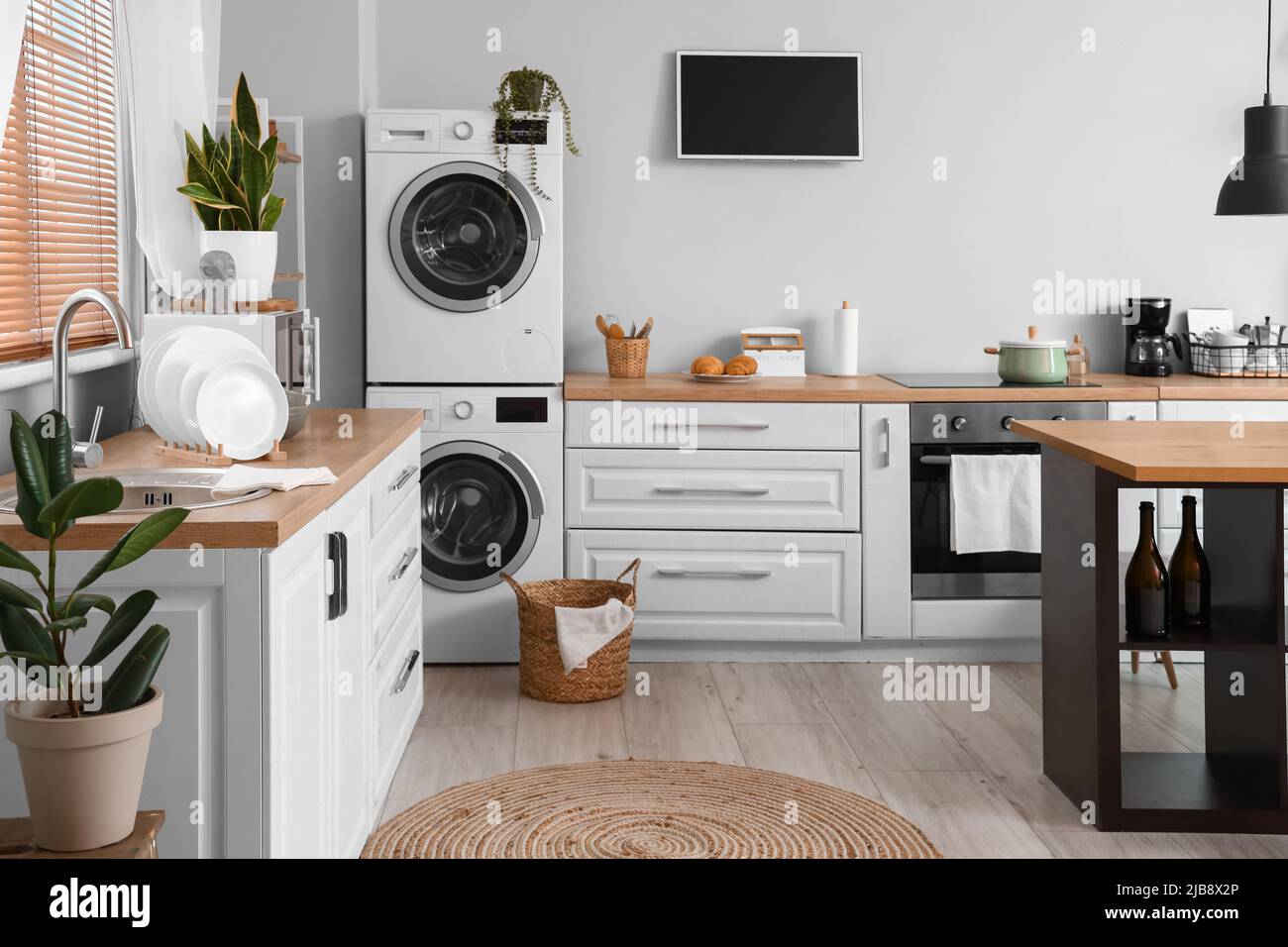 Stylish interior of kitchen with modern washing machines Stock Photo ...