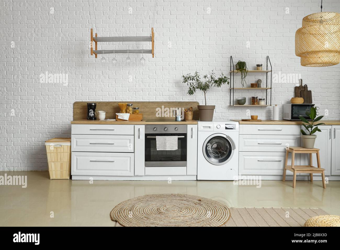 Stylish interior of kitchen with modern washing machine Stock Photo - Alamy