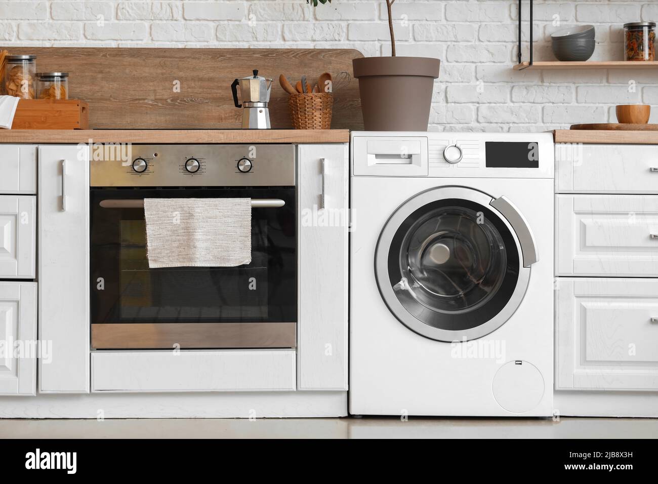 Stylish interior of kitchen with modern washing machine Stock Photo - Alamy