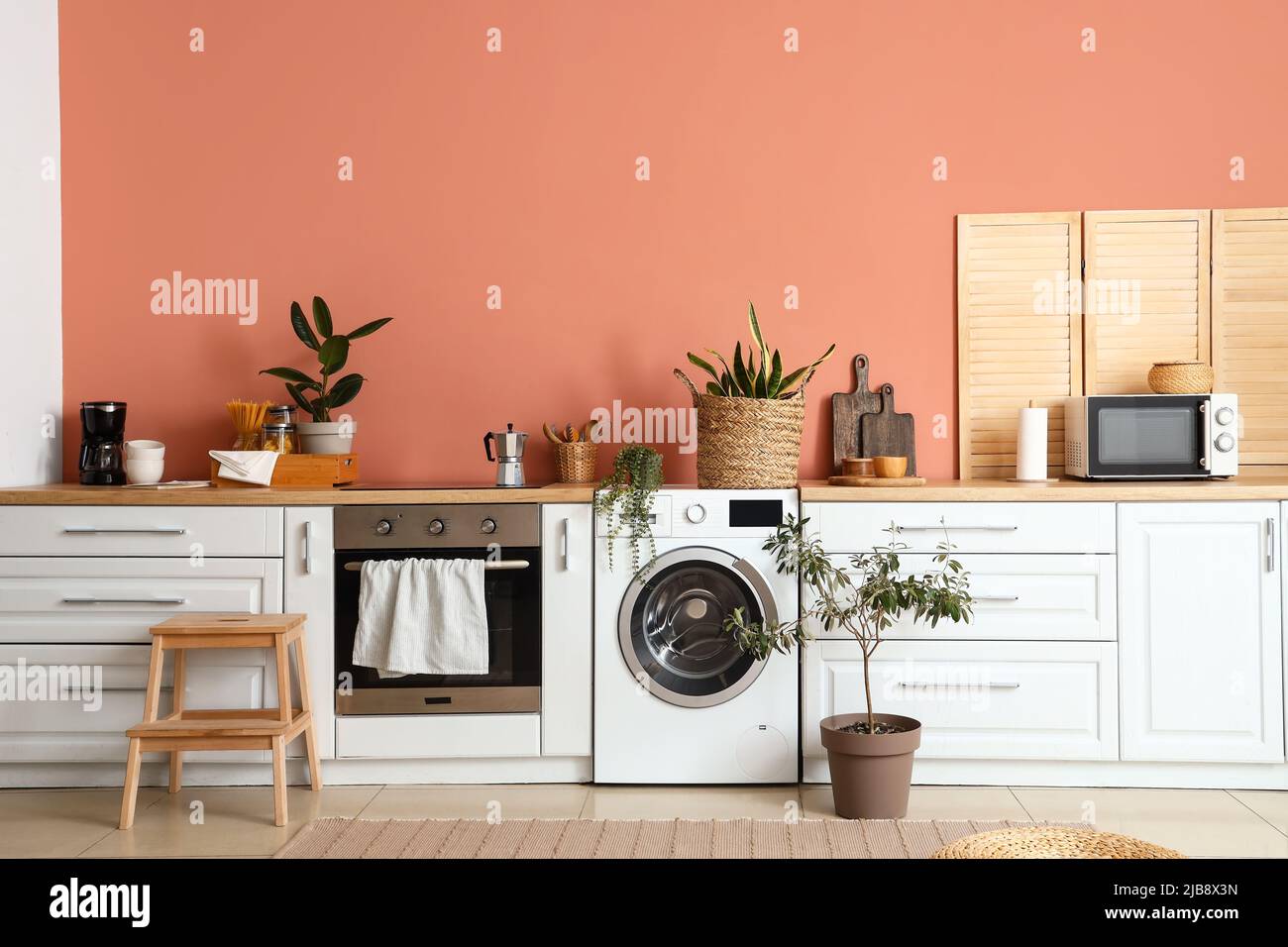 Stylish interior of kitchen with modern washing machine Stock Photo - Alamy