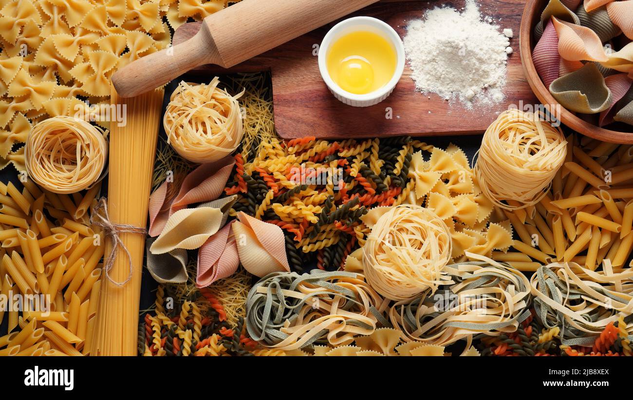 Assortment of raw pasta. Different kinds of macaroni, tagliatelle ...