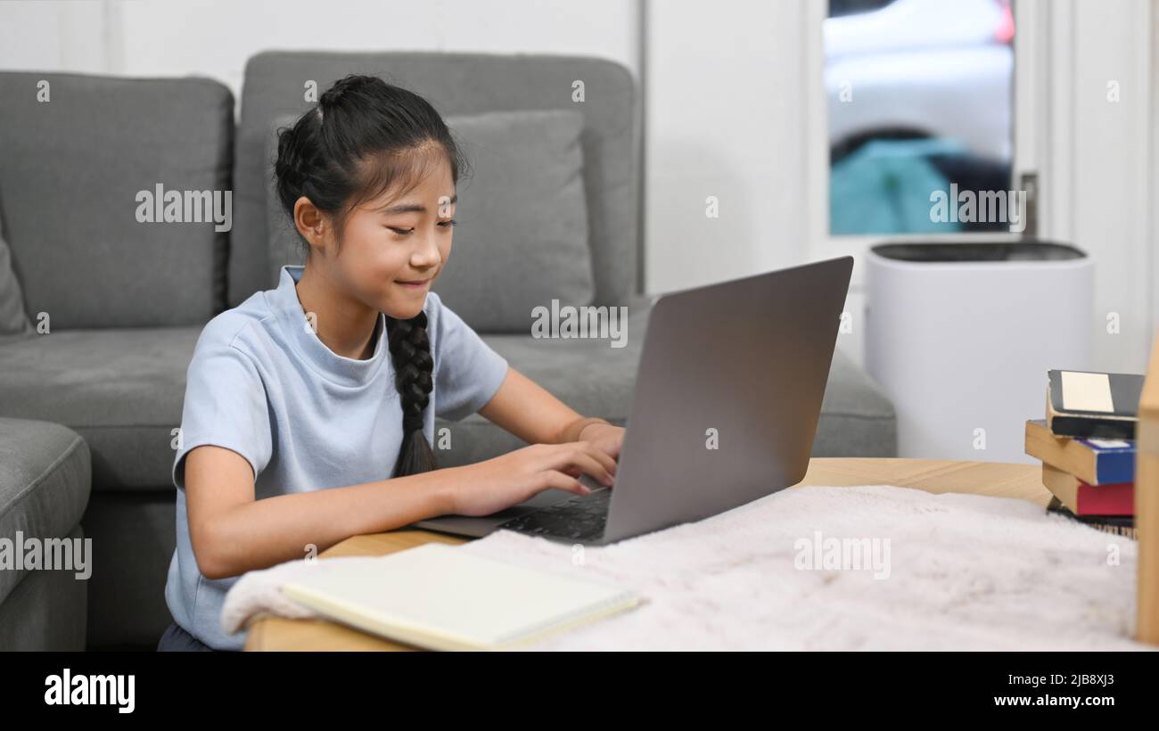Girl doing homework in classroom hi-res stock photography and images ...
