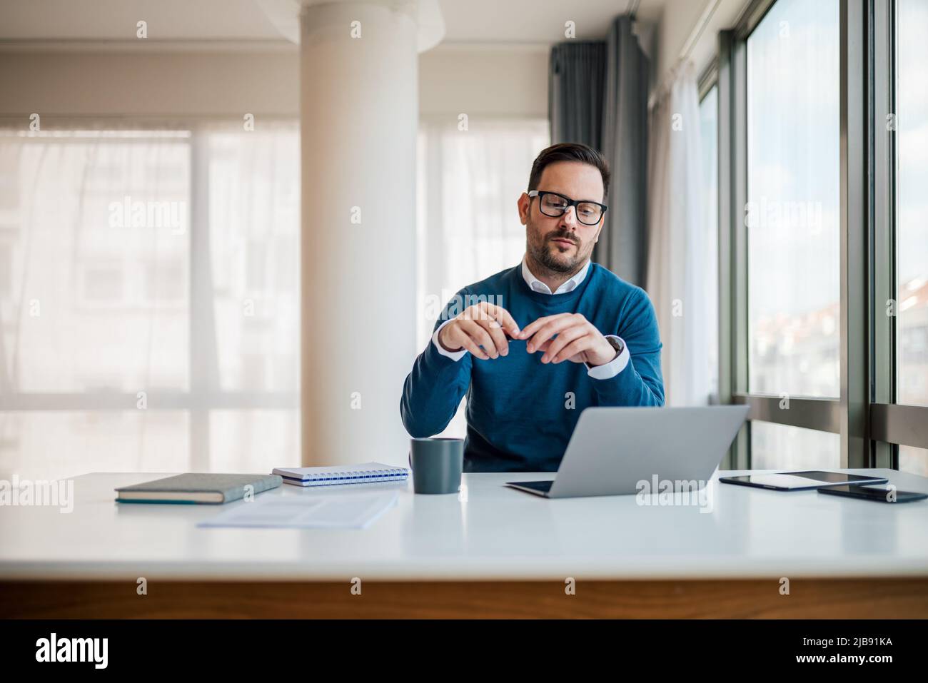 Serious thoughtful manager analyzing business plan on laptop. Male ...