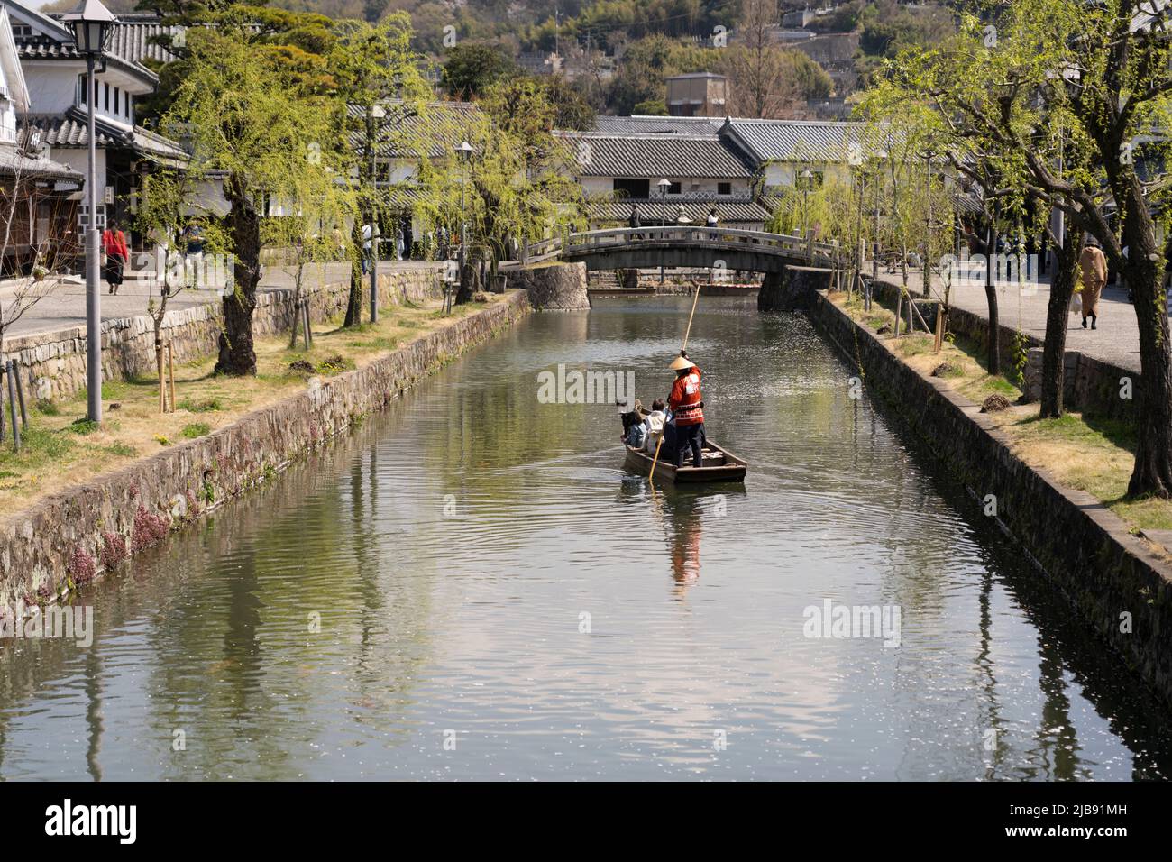Tourists on a boat ride on the Kurashiki River, Kurashiki Bikan ...