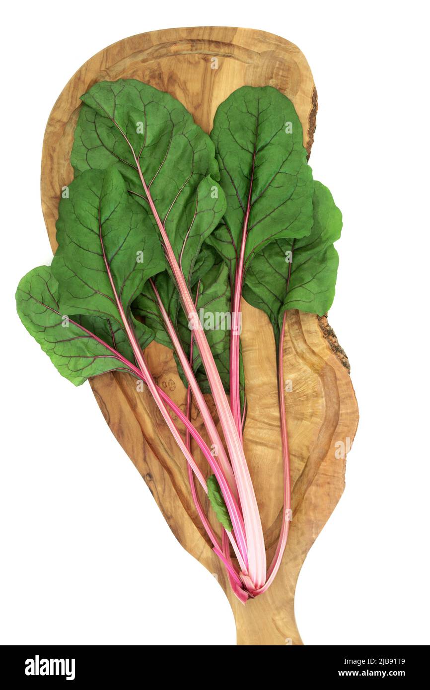 Swiss chard ruby red vegetable leaves on olive wood board. Very high in ...