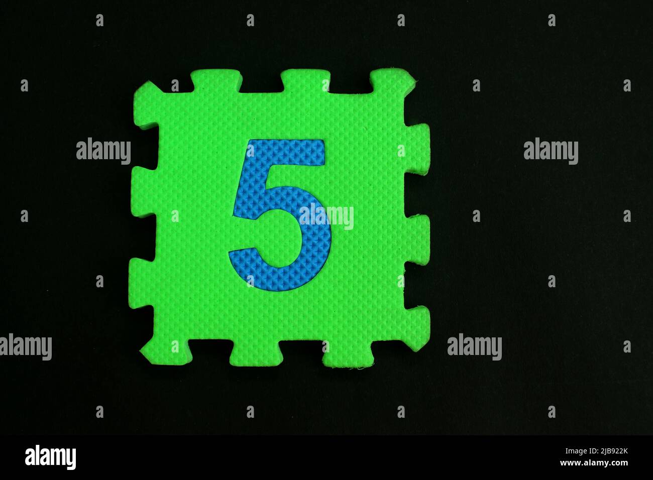 Colorful number puzzle isolated on black background. Number learning ...
