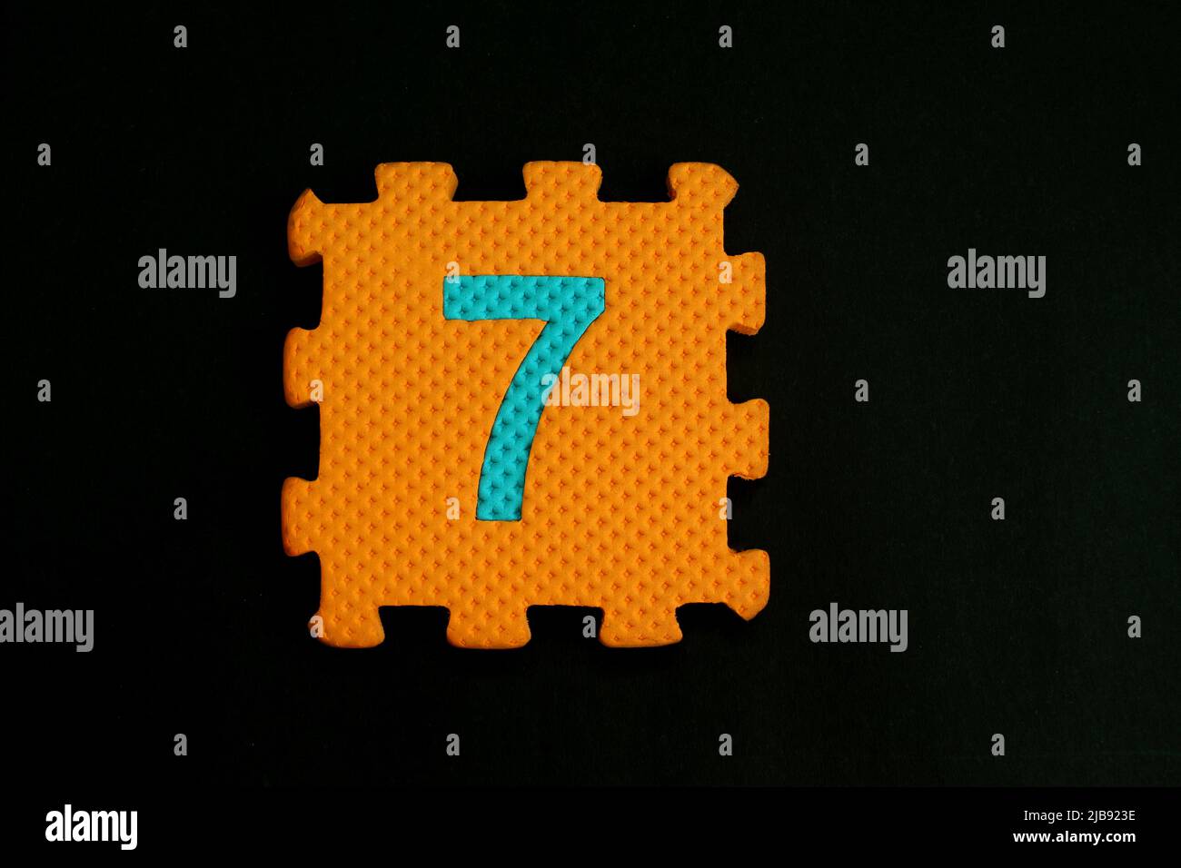 Colorful number puzzle isolated on black background. Number learning ...