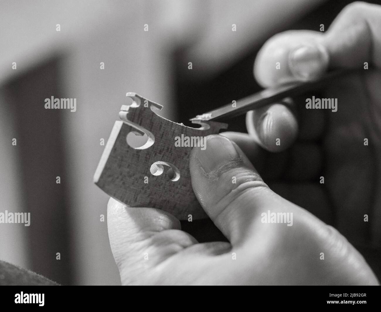 artisan shaving a bridge for precision instrument placement Stock Photo ...