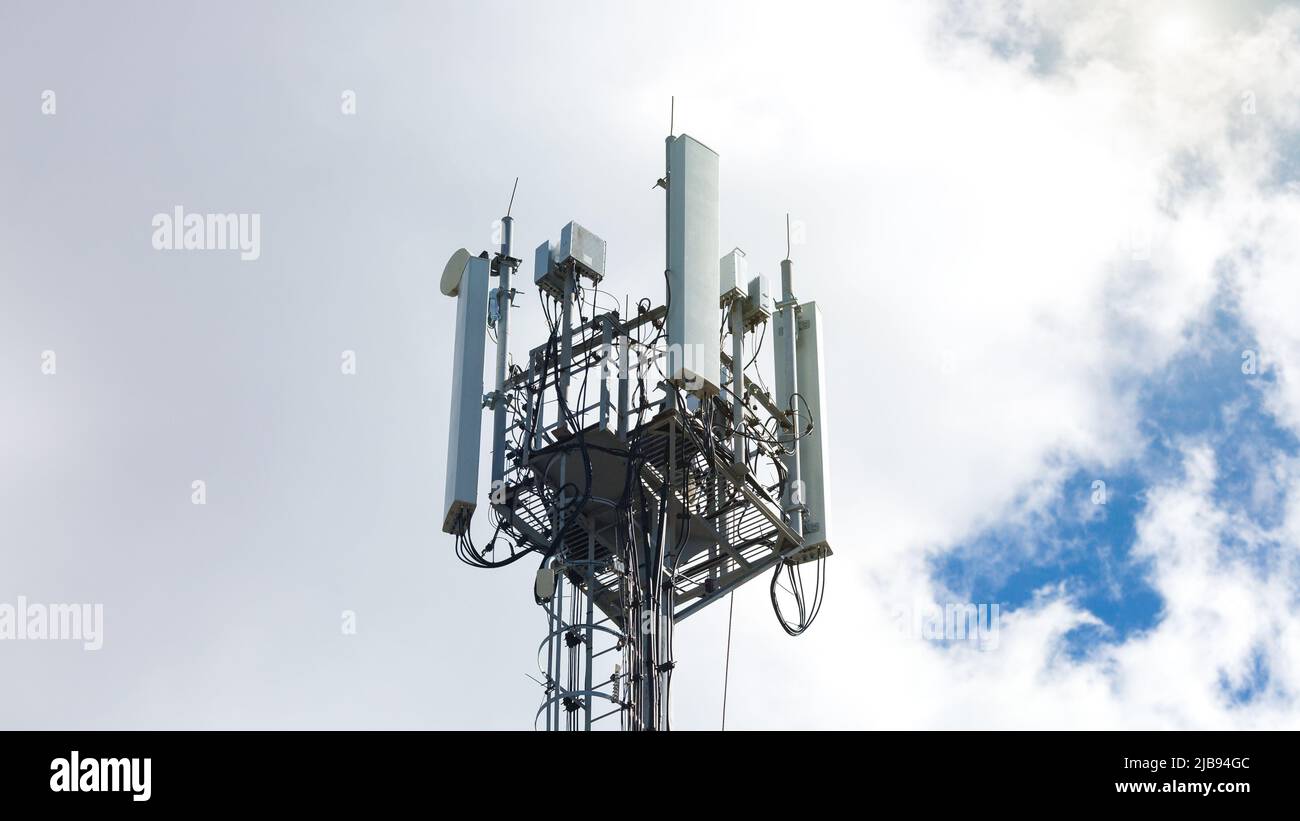 Tower with equipment for cellular communication, 3G, 4G, 5G signal station against the blue sky ...