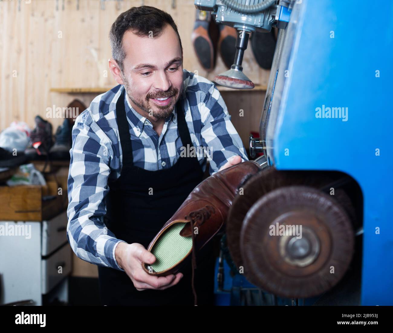 Male worker repairing shoe Stock Photo - Alamy