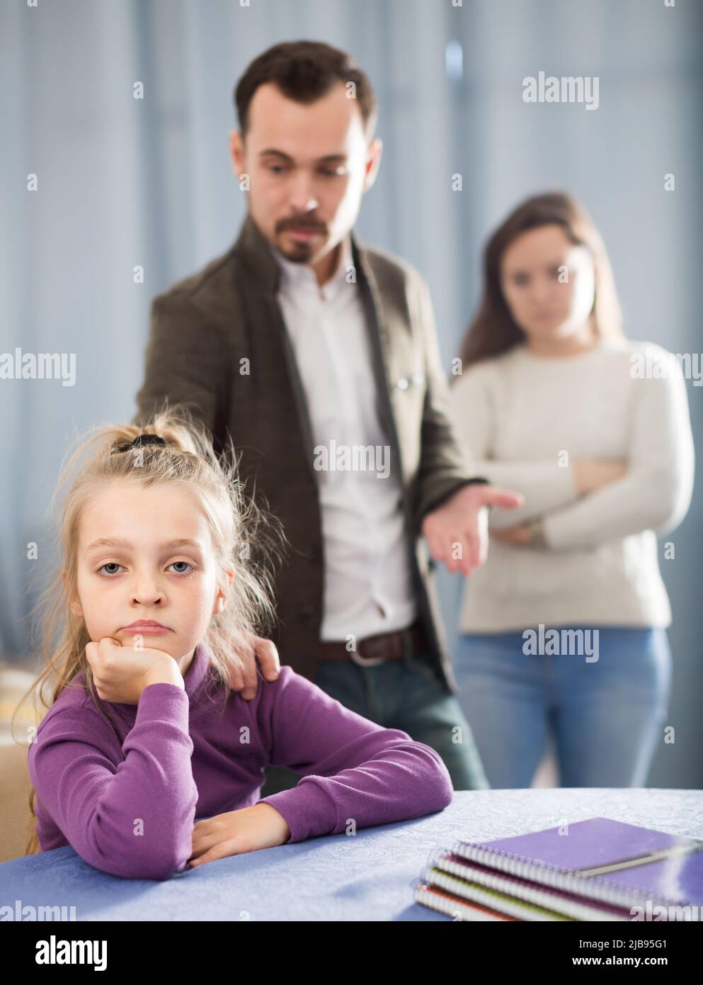 Ordinary parents lecturing girl for bad behavior Stock Photo - Alamy